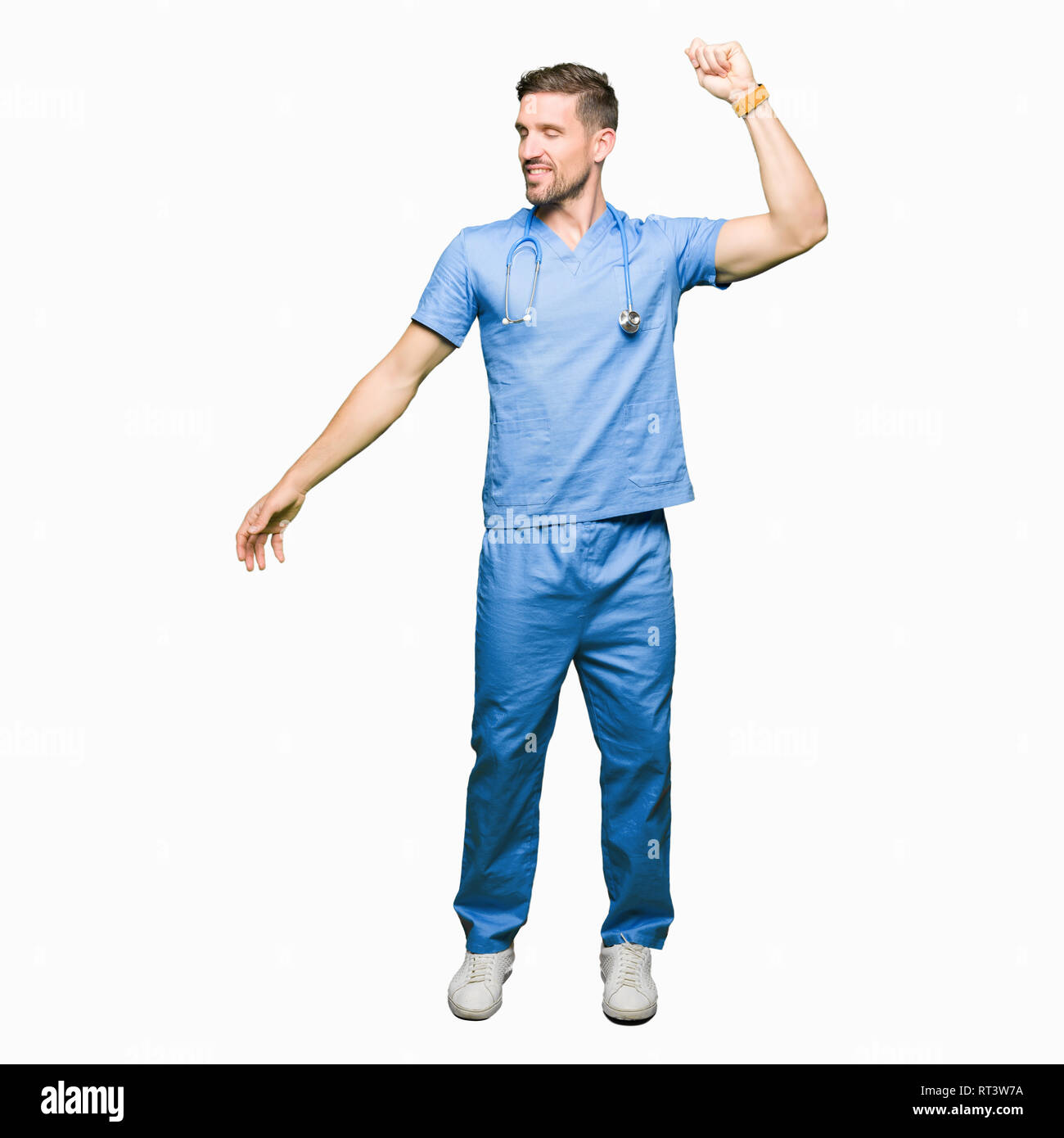 Handsome doctor man wearing medical uniform over isolated background ...