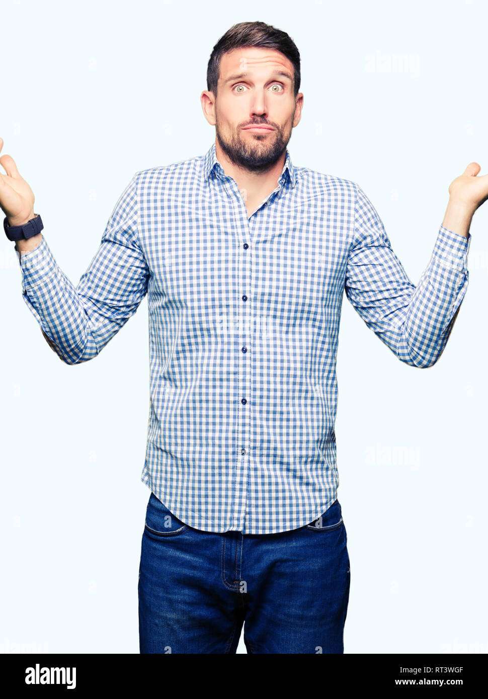 Handsome business man with blue eyes clueless and confused expression ...