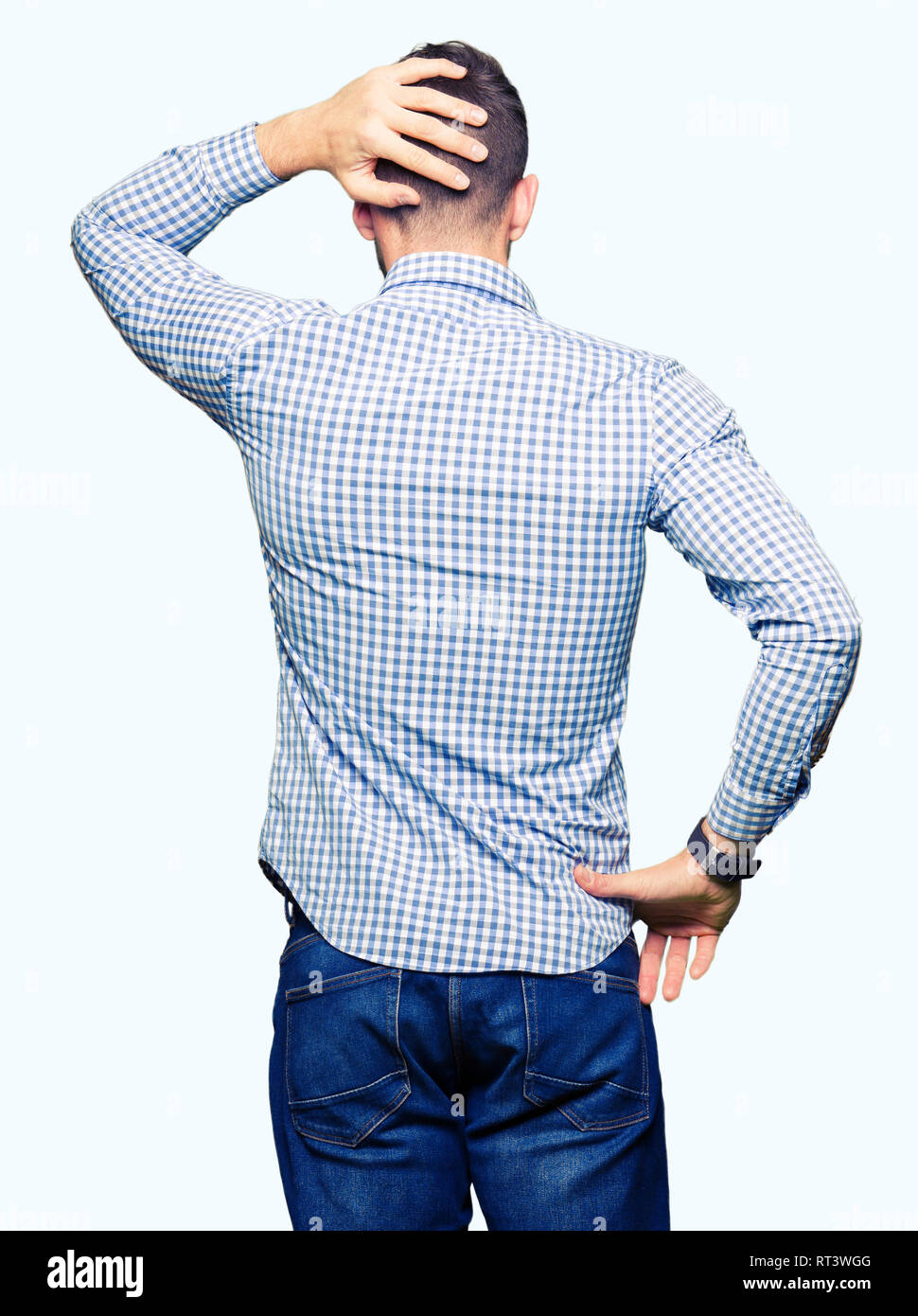 Handsome business man with blue eyes Backwards thinking about doubt ...