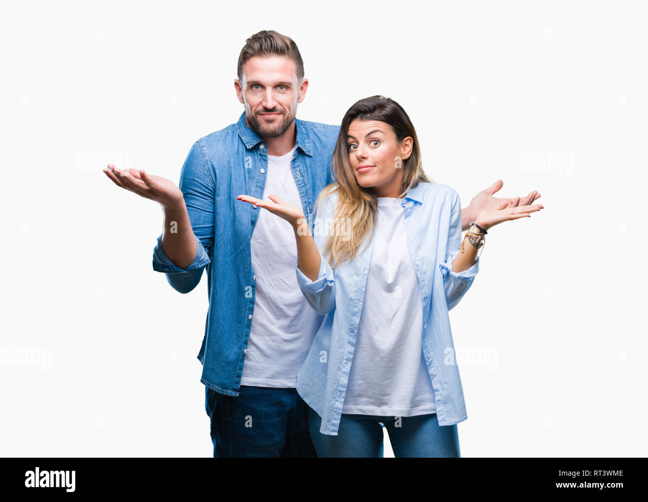 Young couple in love over isolated background clueless and confused ...