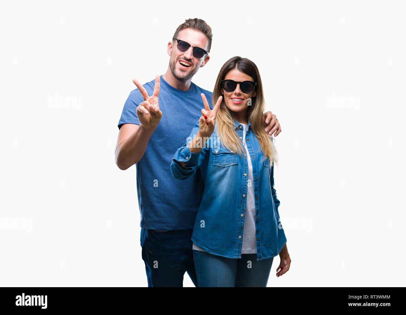 Young couple in love wearing sunglasses over isolated background ...