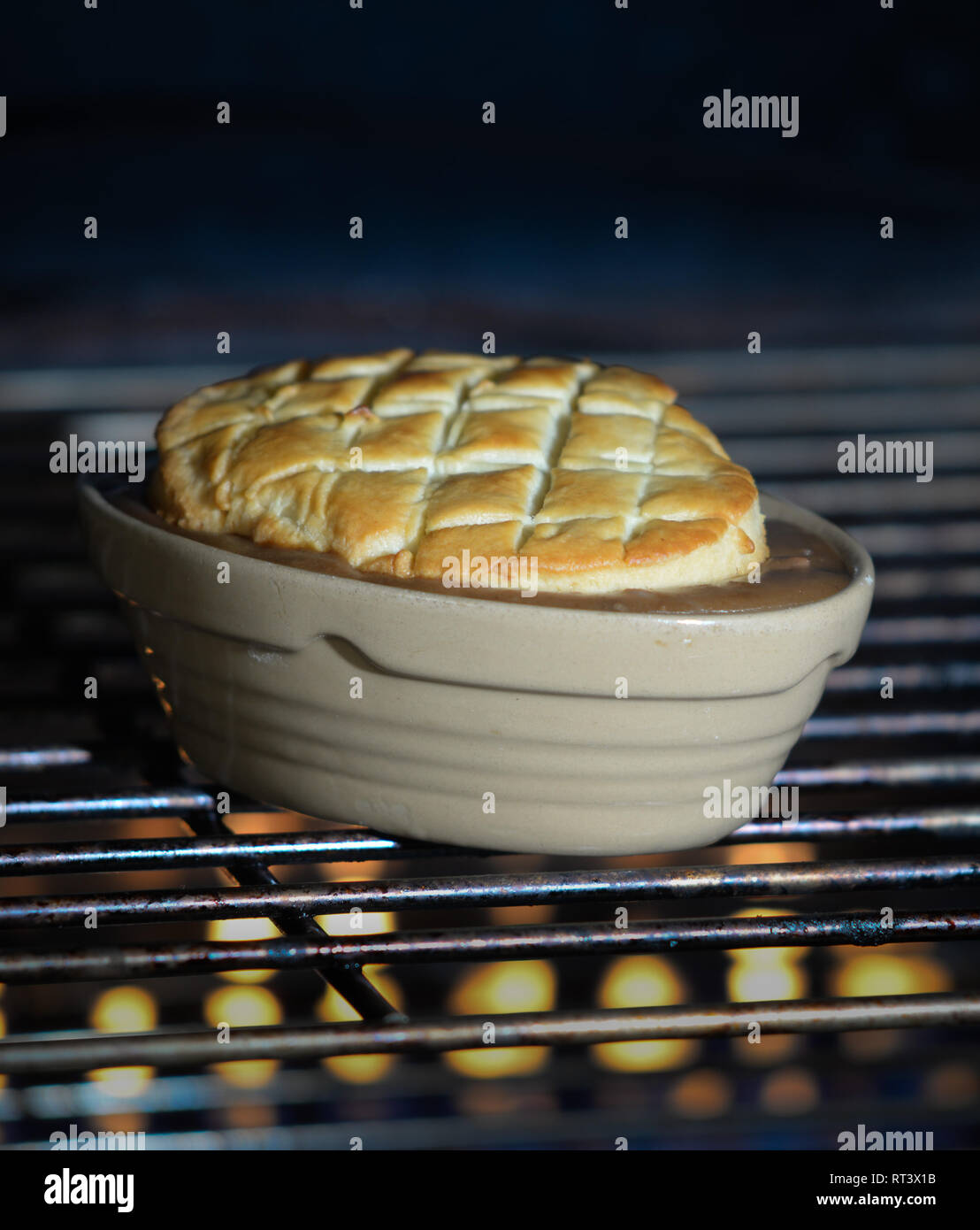 A pie cooking in a gas oven Stock Photo - Alamy