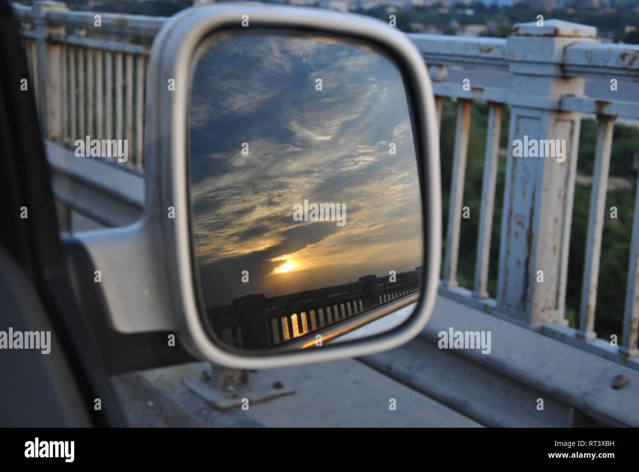 Sunset in the car mirror Stock Photo - Alamy