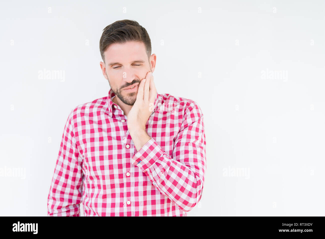 Young handsome man wearing shirt over isolated background touching ...