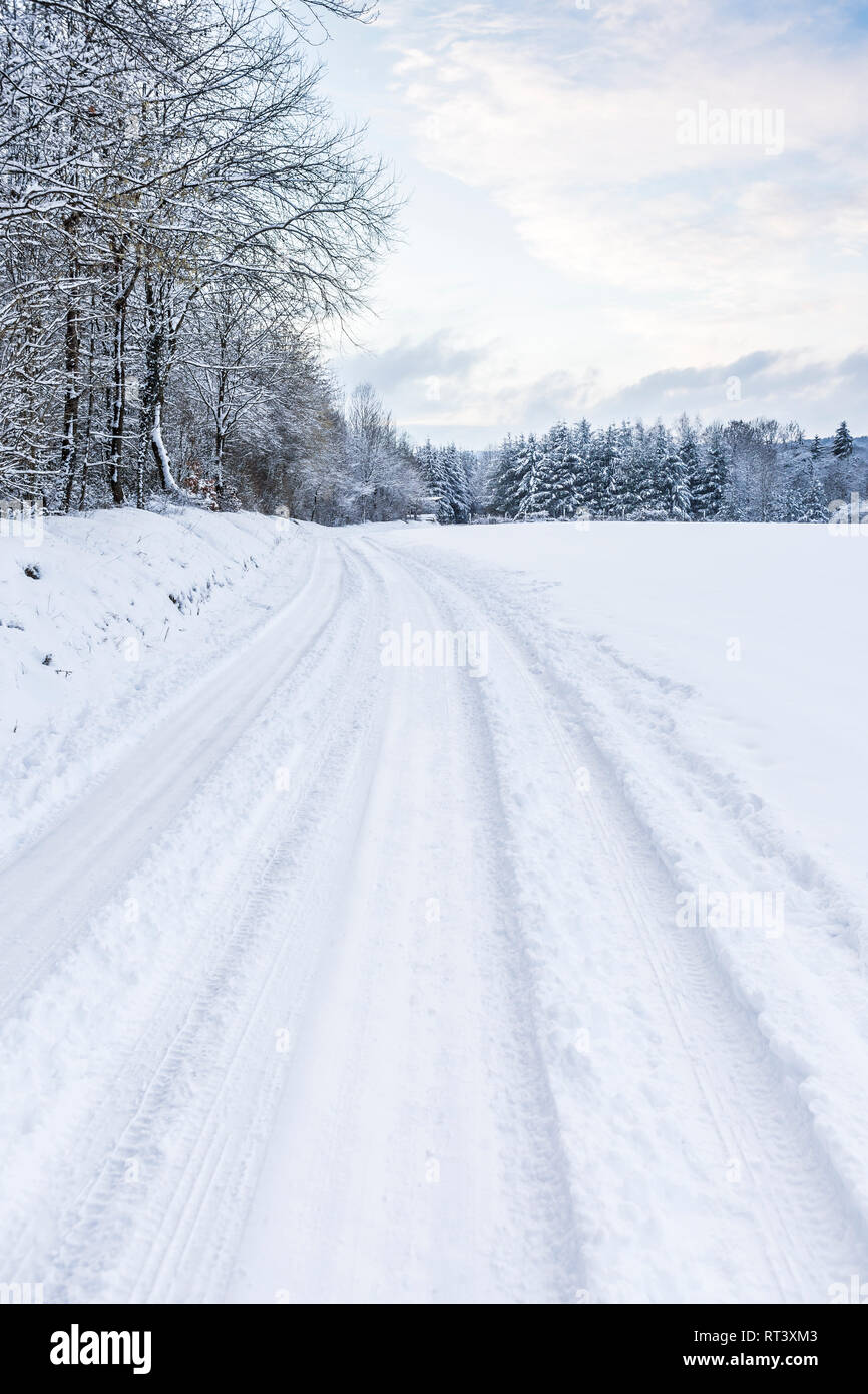 Snow covered road and winter landscape Stock Photo - Alamy