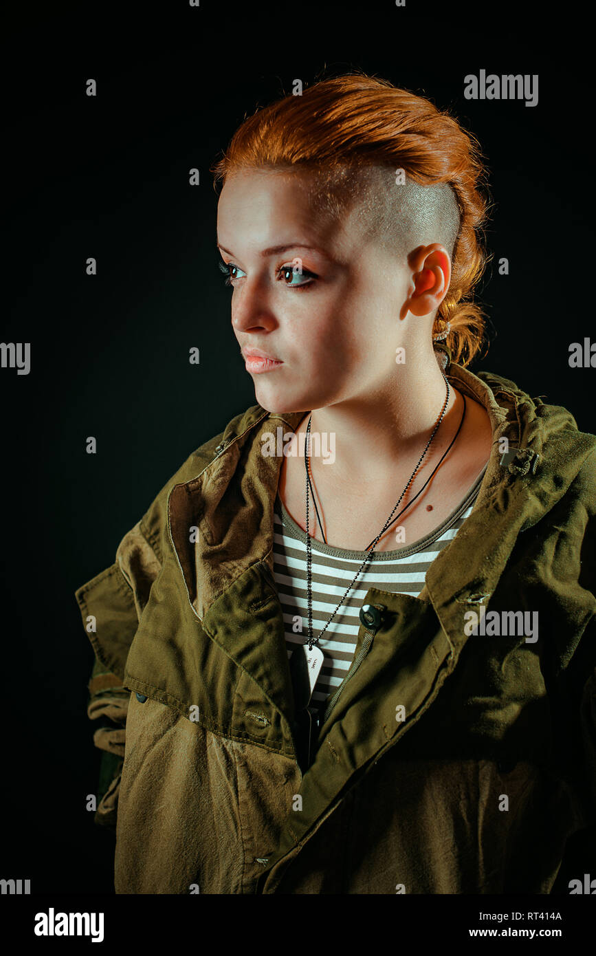 Young woman with red hair in military green uniform Stock Photo - Alamy