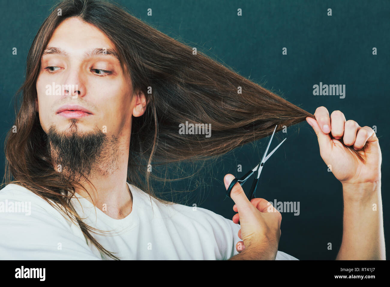 Trim and cut concept. Young handsome man cutting his hair. Change of ...