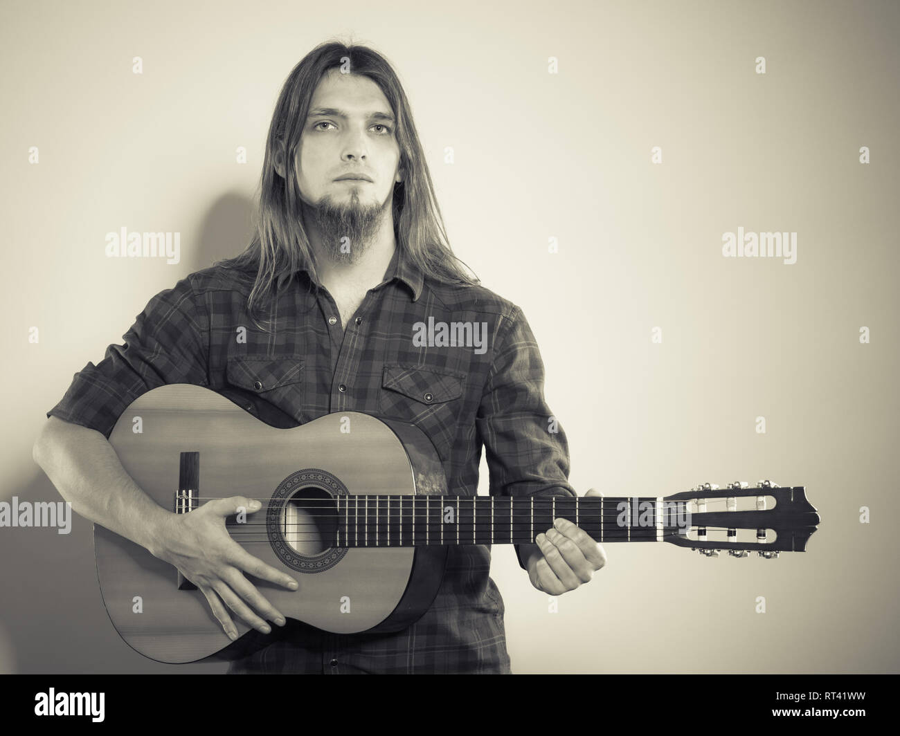 Hobby passion concept. Guitarist is playing the guitar. Long haired ...