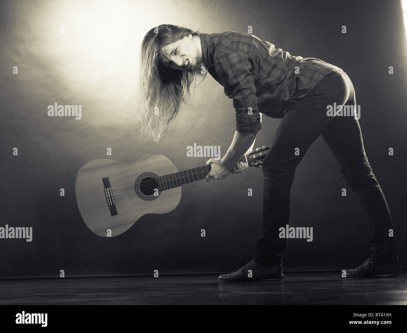 Rock music energy people feelings concept. Mad rock guitarist destroys ...