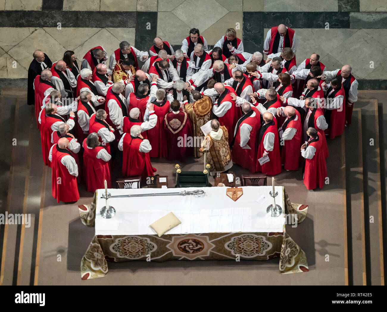 The laying on of hands during a double consecration of the The Reverend ...