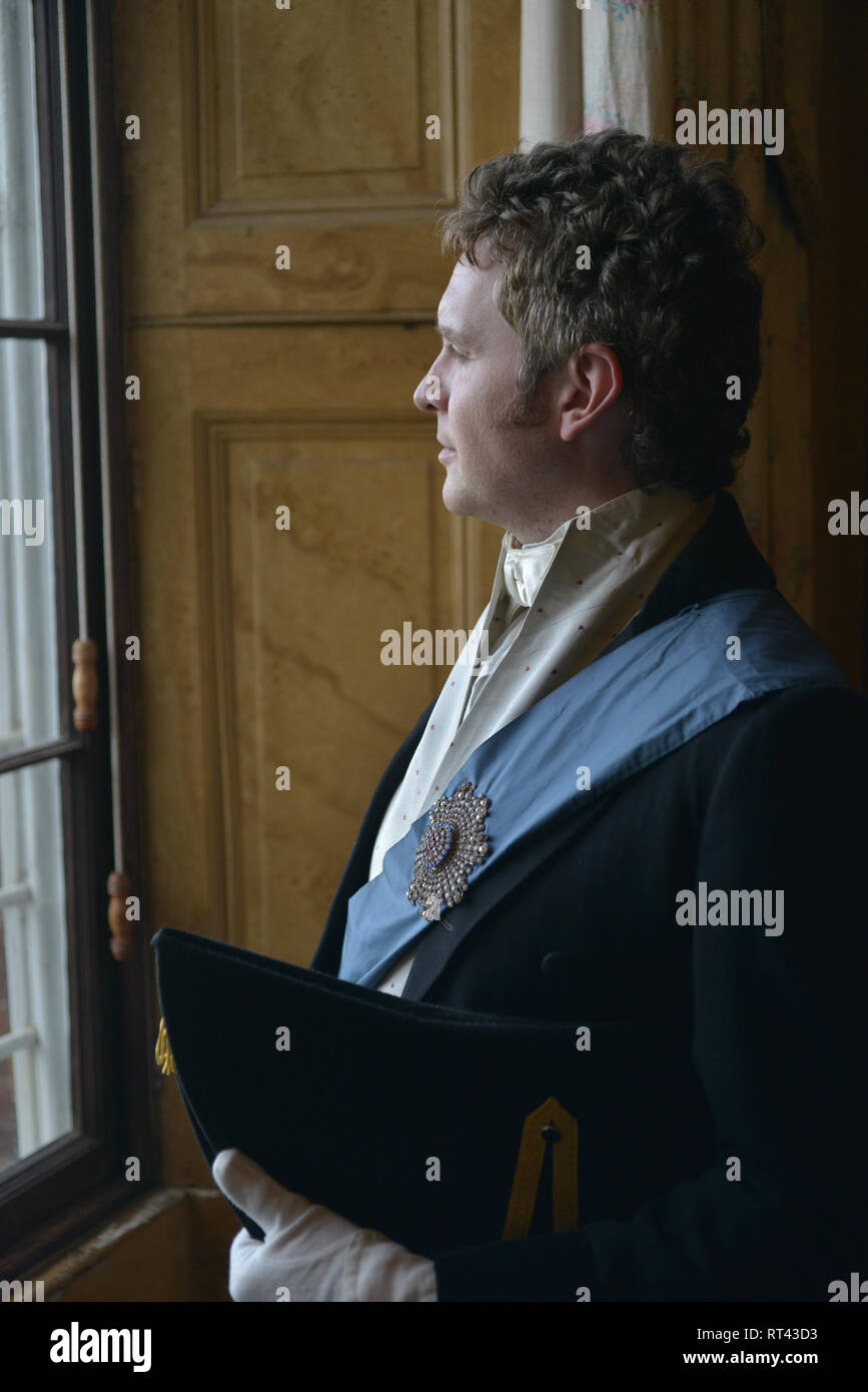 A handsome man dressed as a Victorian office wearing expensive clothes ...