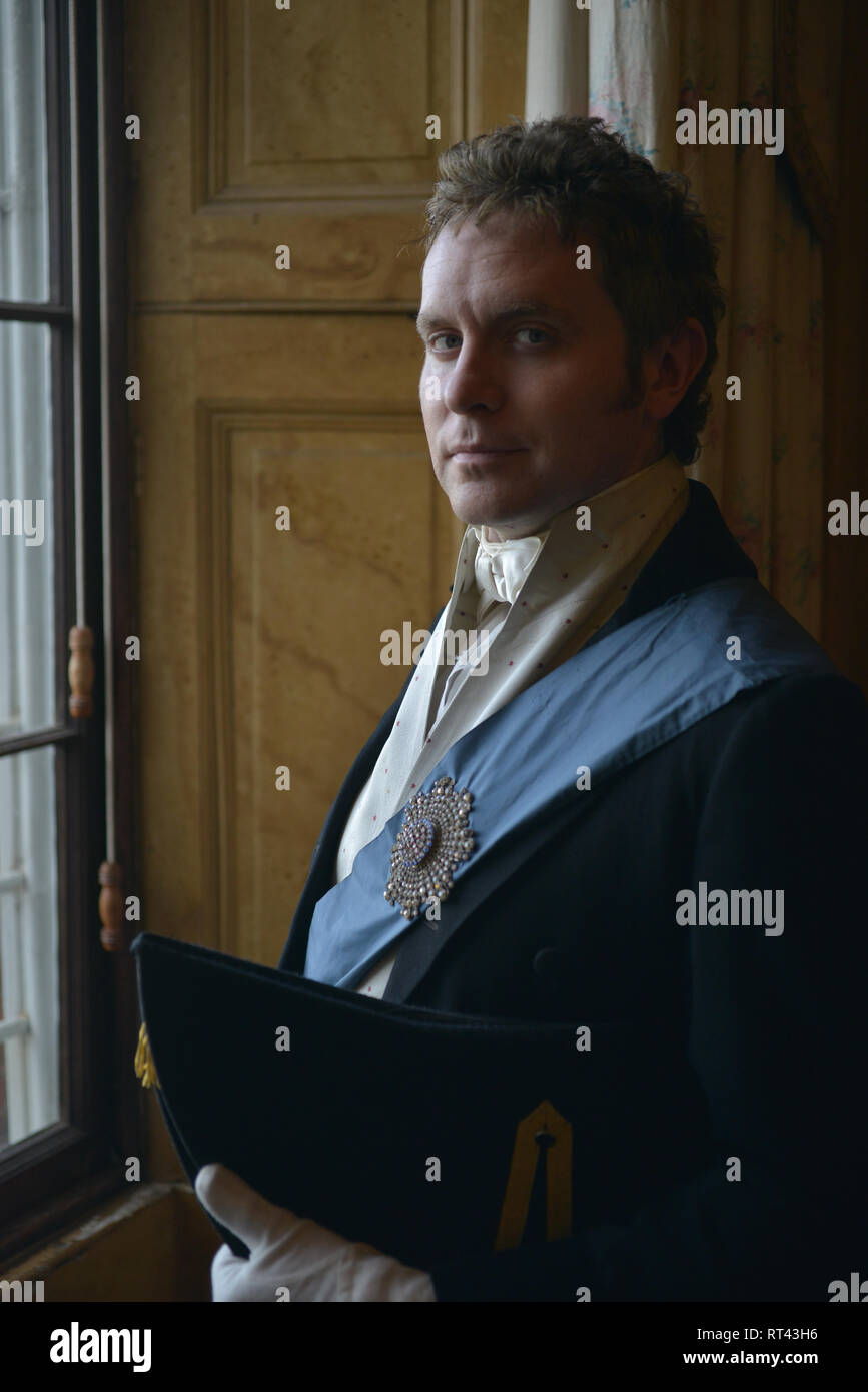 A handsome man dressed as a Victorian office wearing expensive clothes ...