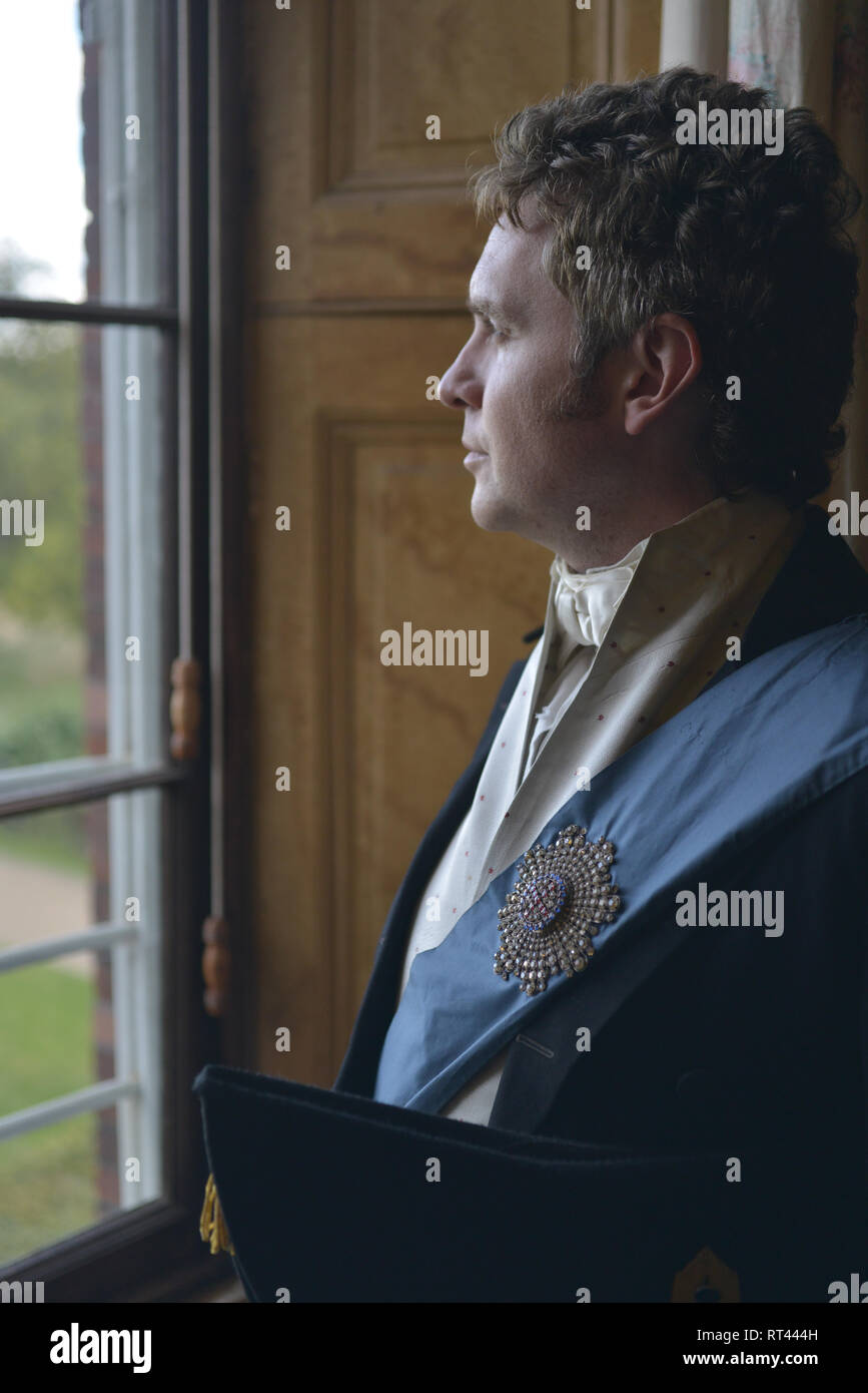 A handsome man dressed as a Victorian office wearing expensive clothes ...