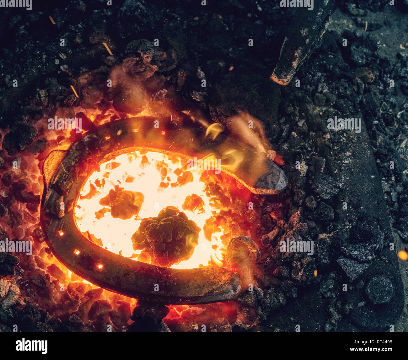 Red fire blazes inside of coal forge. Blacksmith traditional works with ...