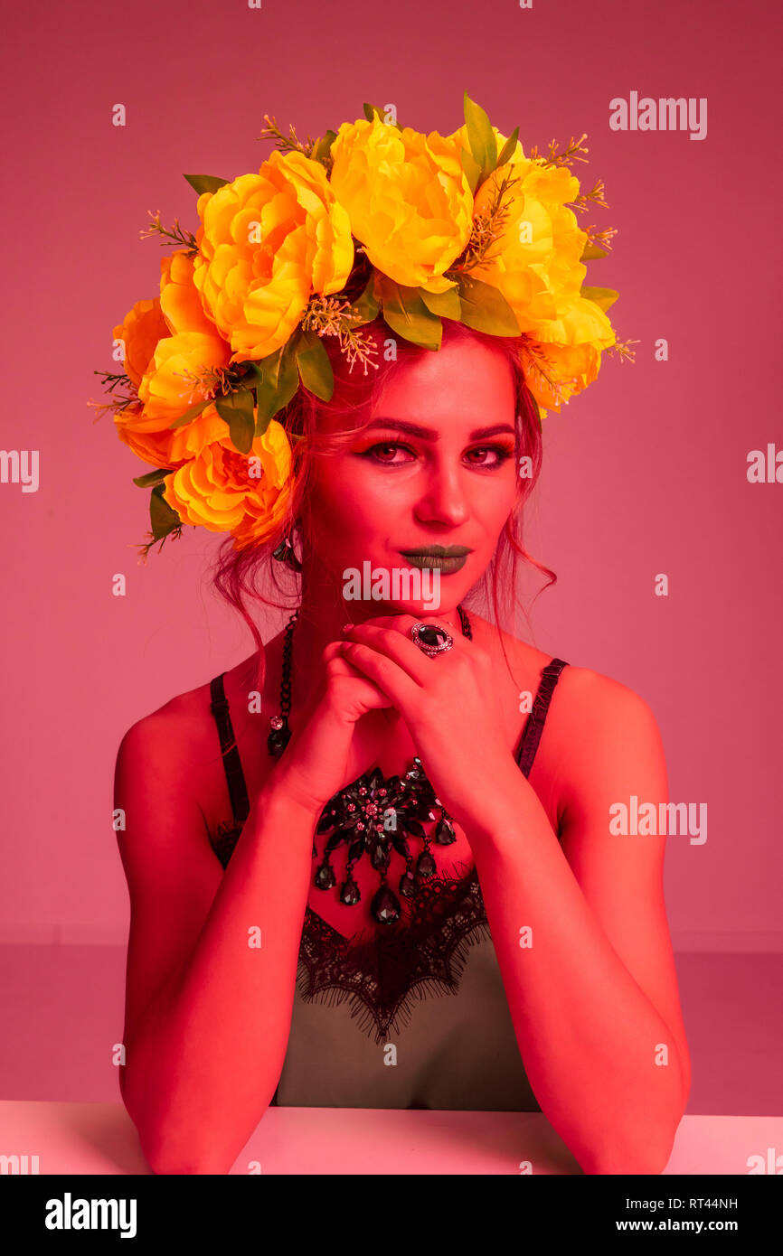 Fashionable portrait of a beautiful girl with a wreath of flowers and ...