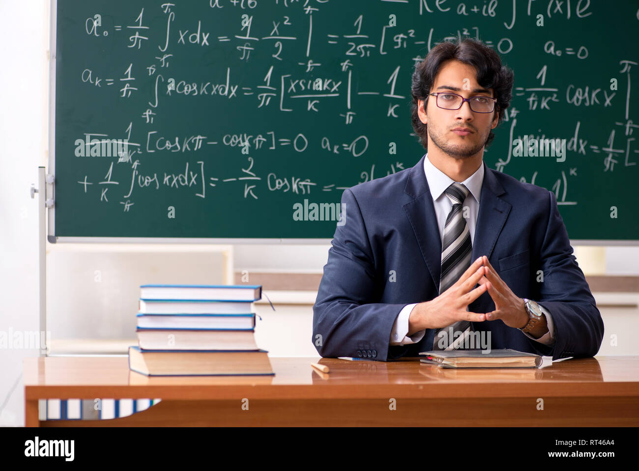 Young male math teacher in classroom Stock Photo - Alamy