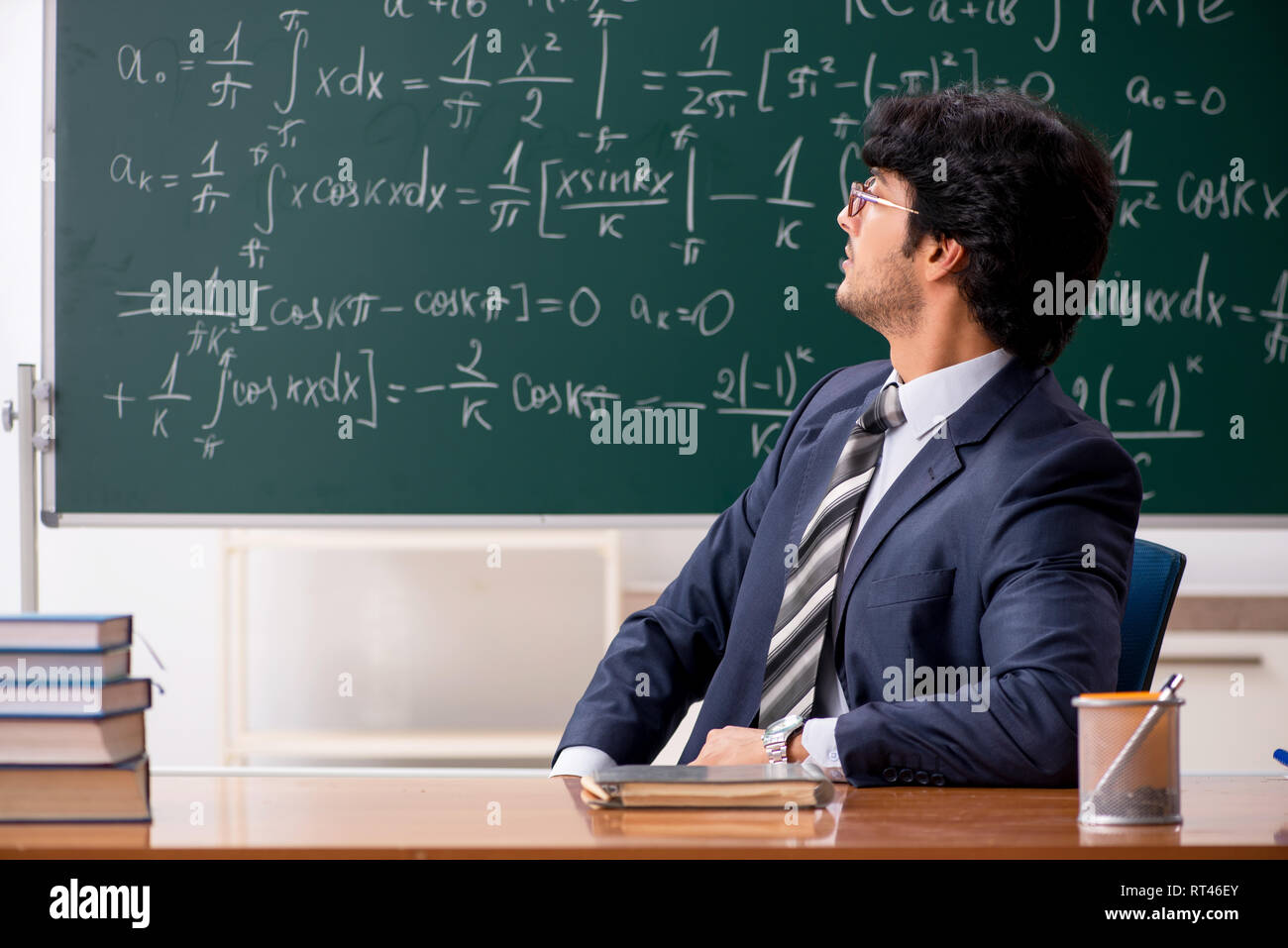 Young male math teacher in classroom Stock Photo - Alamy