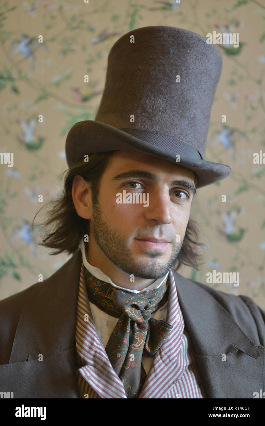 A handsome young Victorian man in a historically accurate suit stands ...
