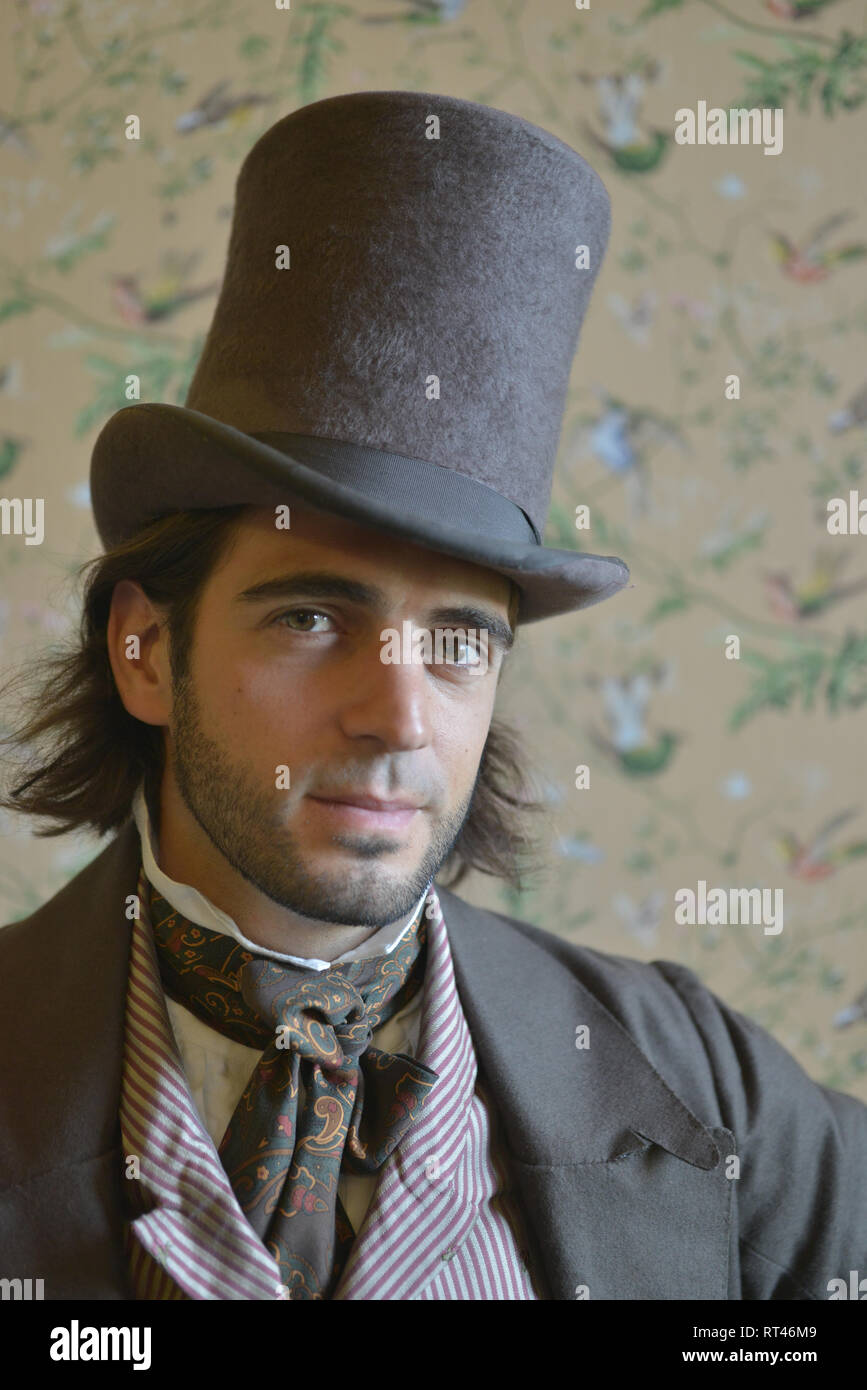 A handsome young Victorian man in a historically accurate suit stands ...