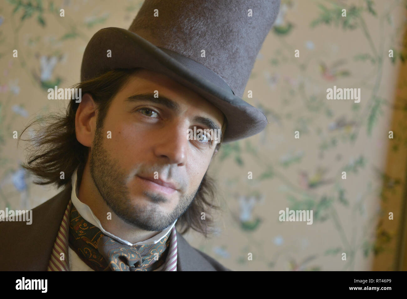 A handsome young Victorian man in a historically accurate suit stands ...