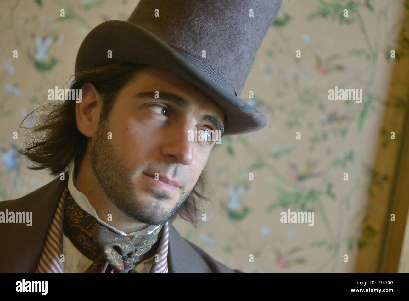A handsome young Victorian man in a historically accurate suit stands ...