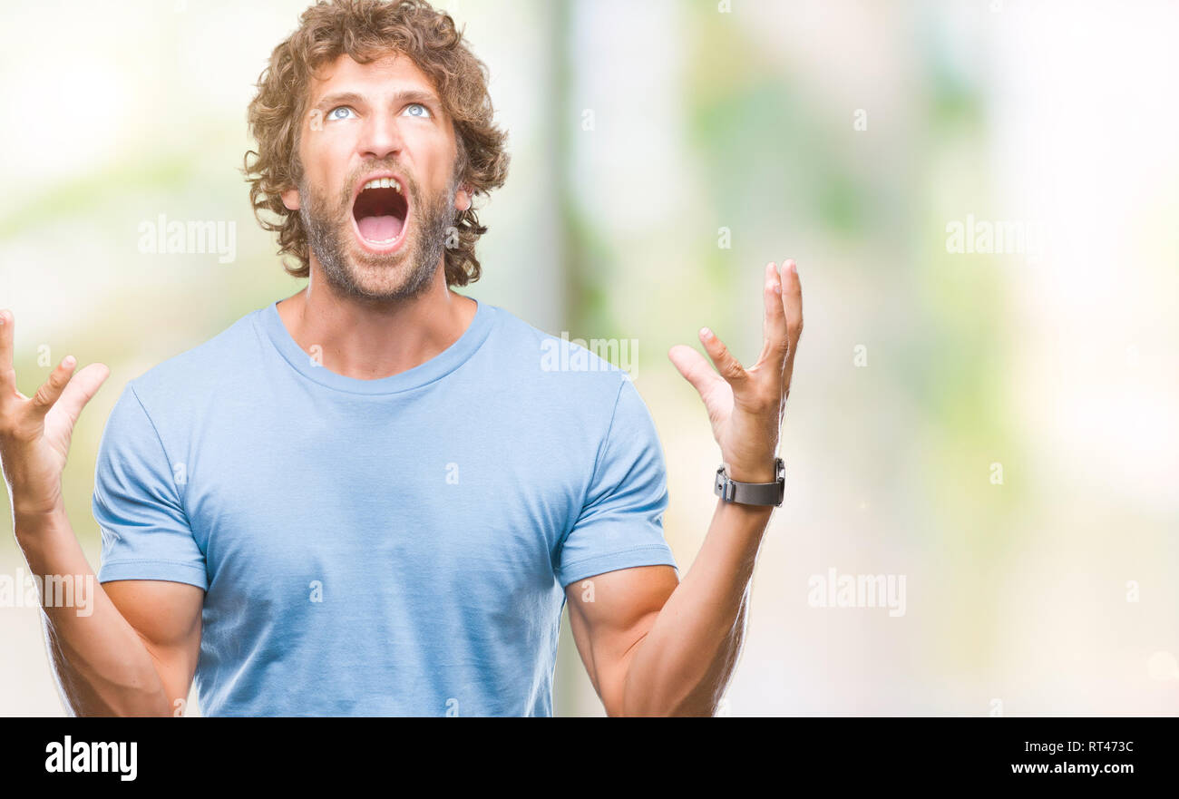 Handsome hispanic model man over isolated background crazy and mad ...