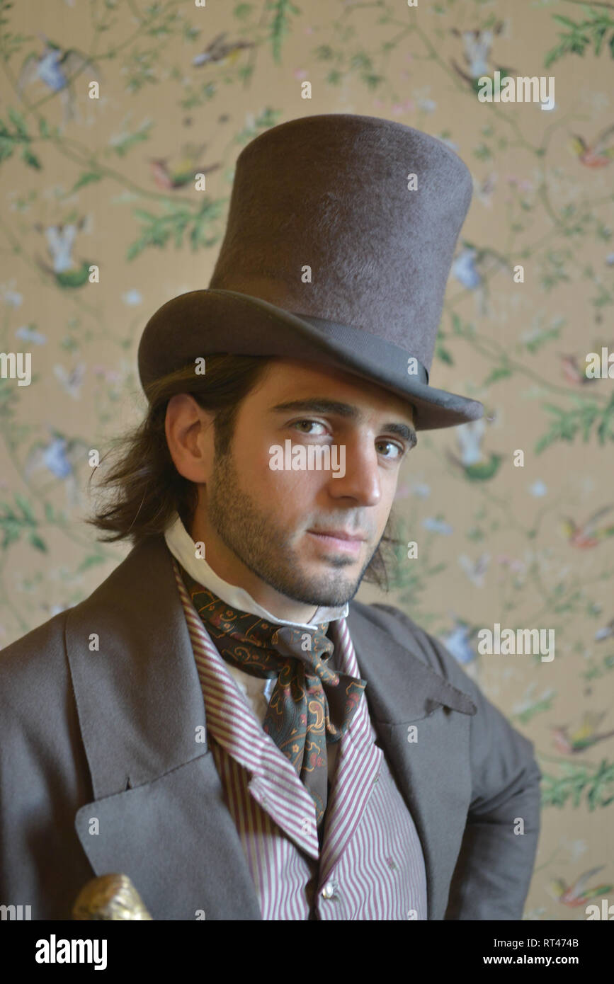 A handsome young Victorian man in a historically accurate suit stands ...