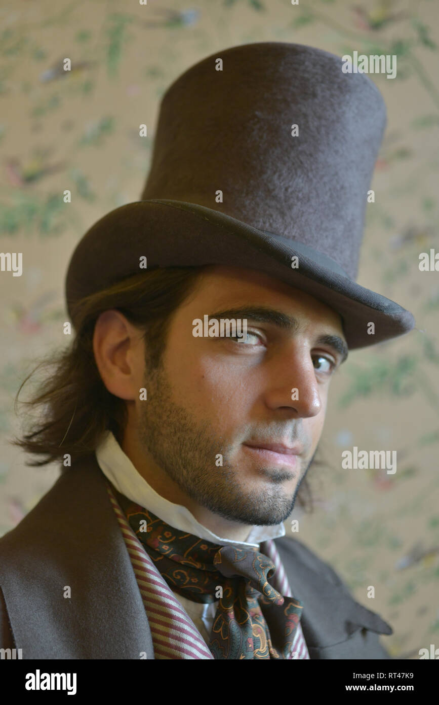 A handsome young Victorian man in a historically accurate suit stands ...