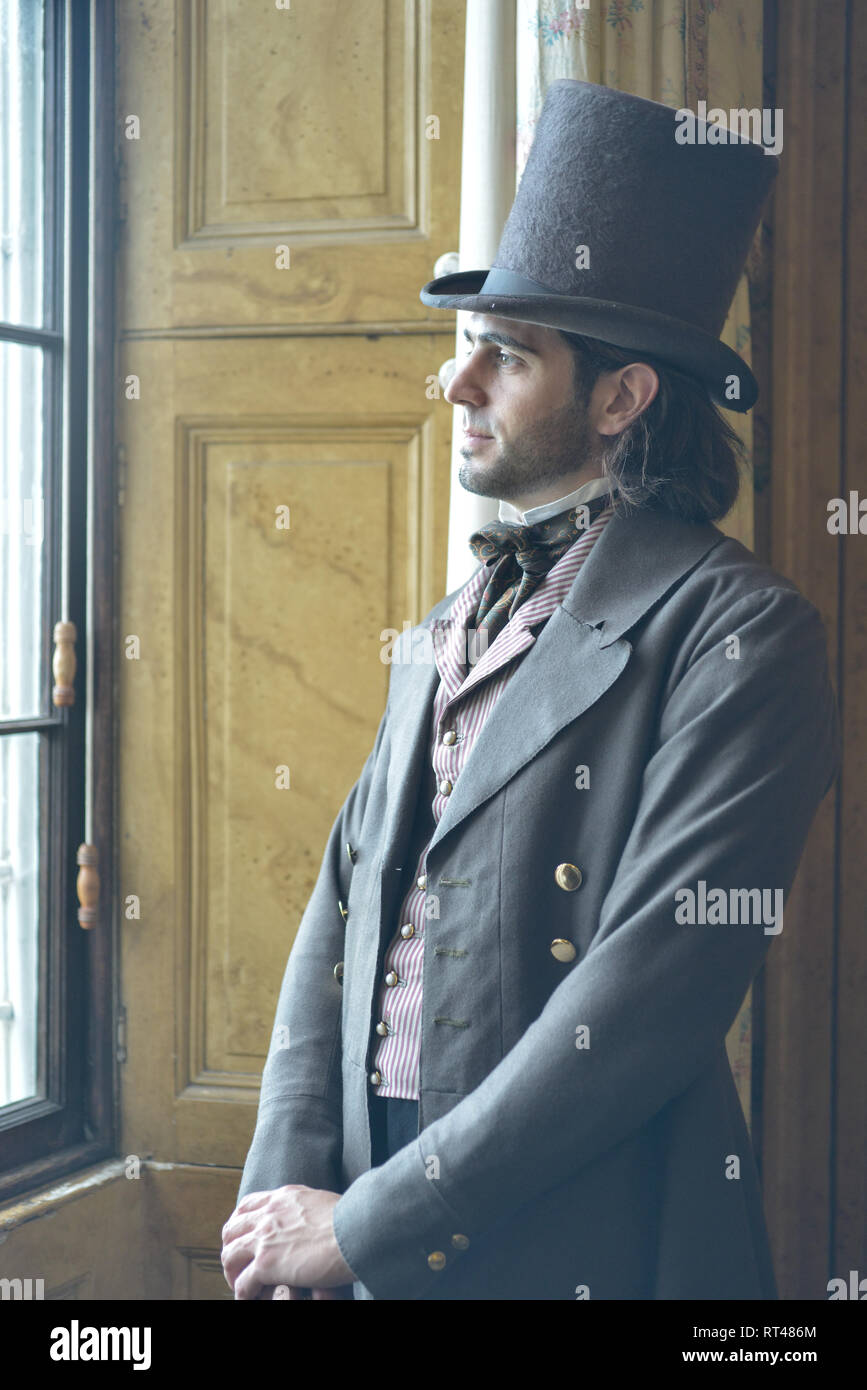 A handsome young Victorian man in a historically accurate suit stands ...