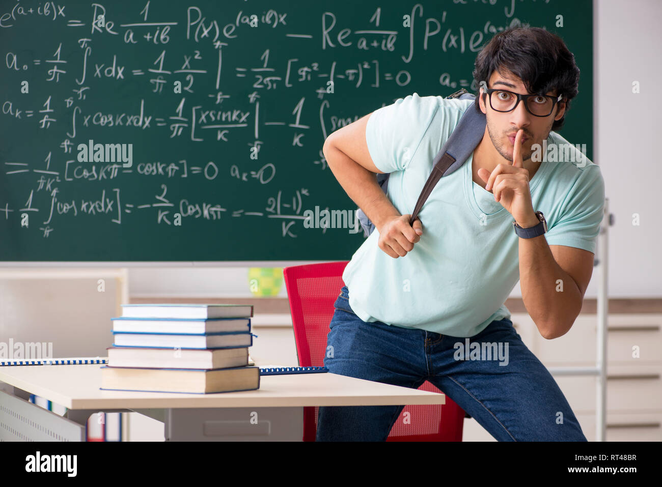 Young male student mathematician in front of chalkboard Stock Photo - Alamy