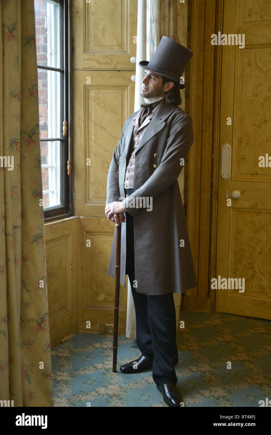 A handsome young Victorian man in a historically accurate suit stands ...