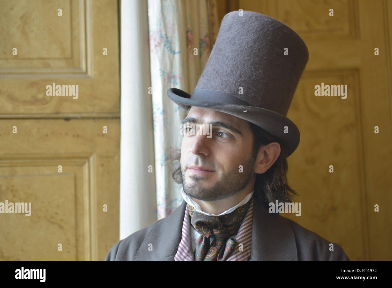 A handsome young Victorian man in a historically accurate suit stands ...