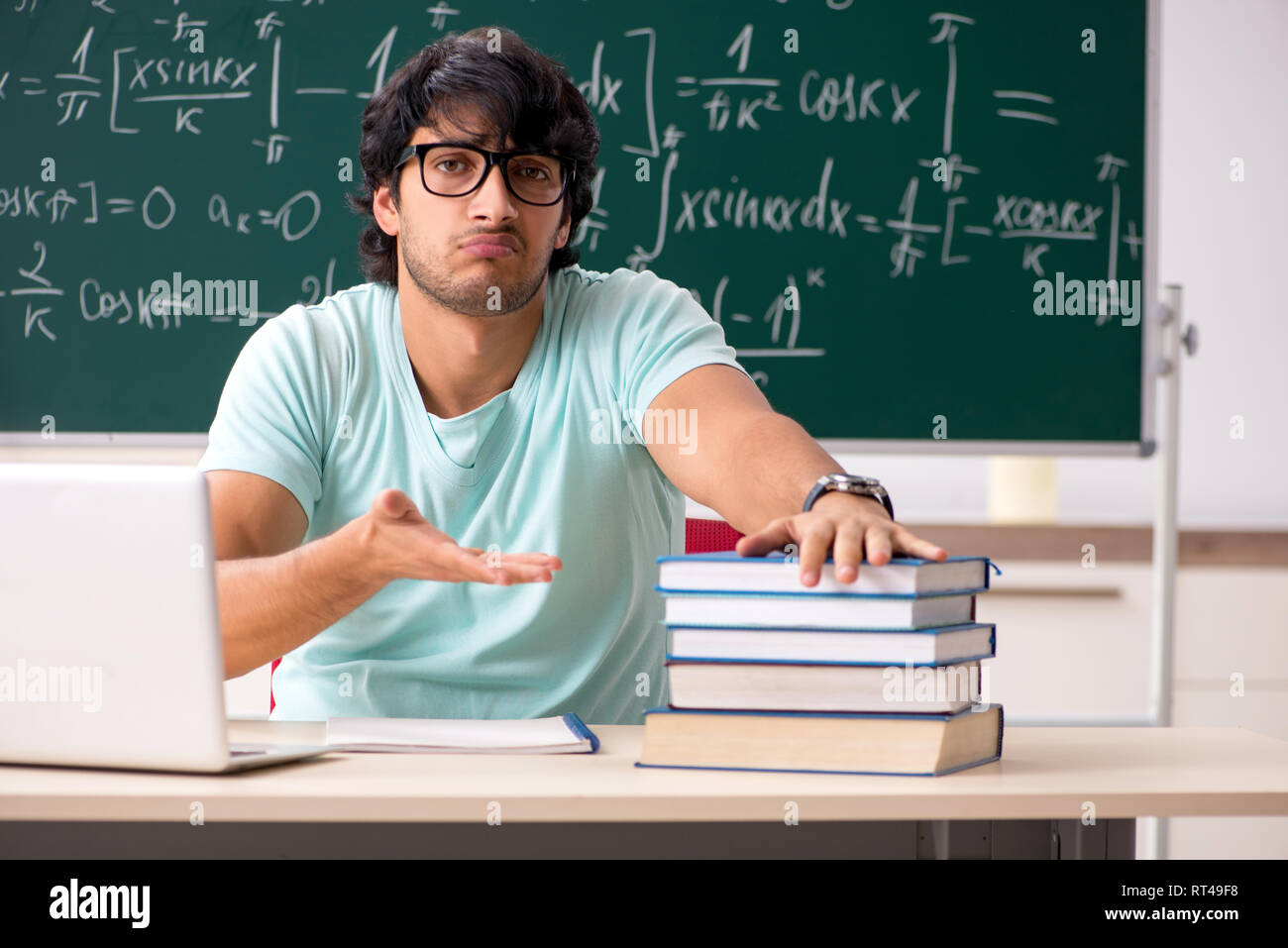 Young male student mathematician in front of chalkboard Stock Photo - Alamy