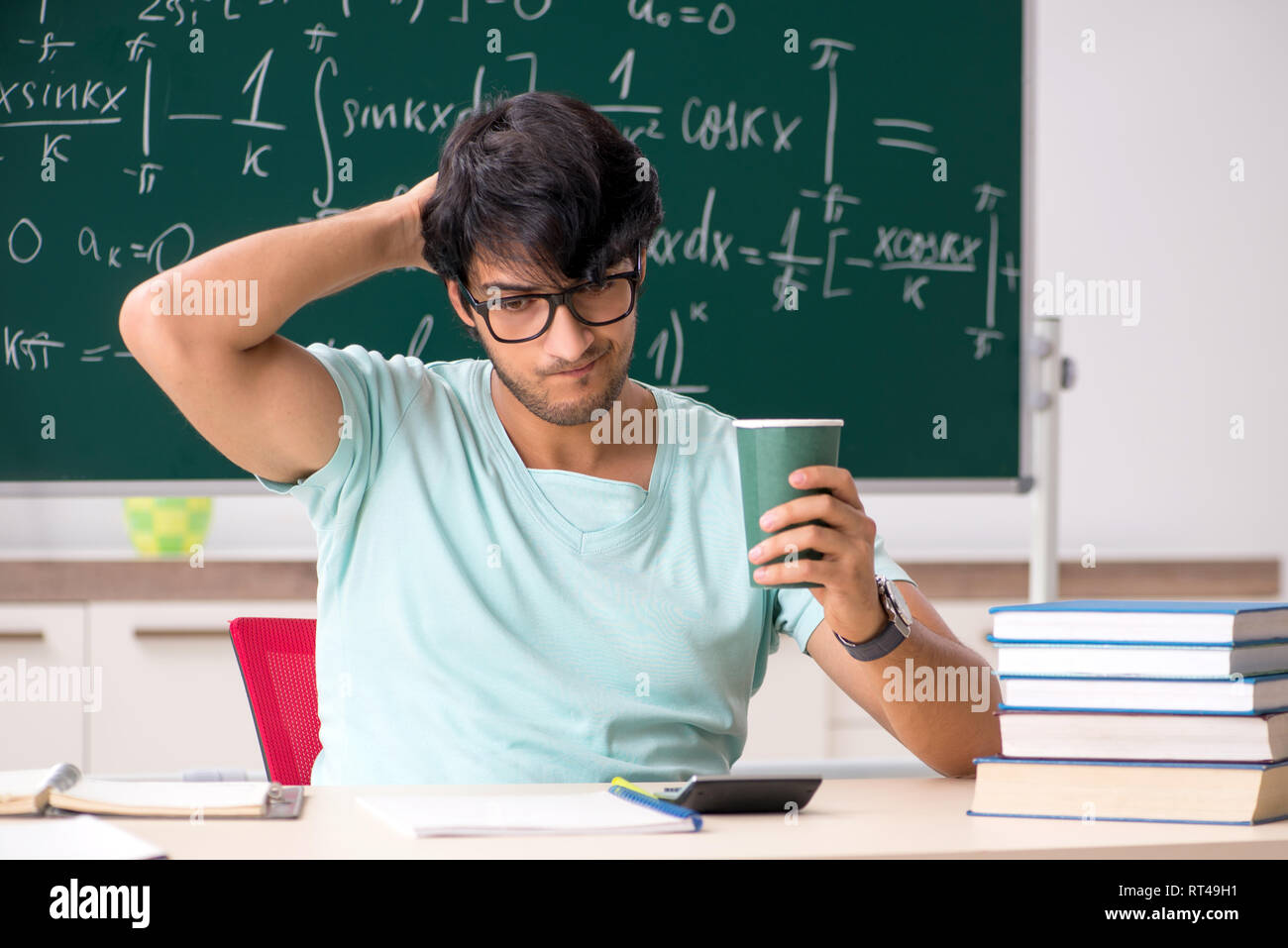 Young male student mathematician in front of chalkboard Stock Photo - Alamy