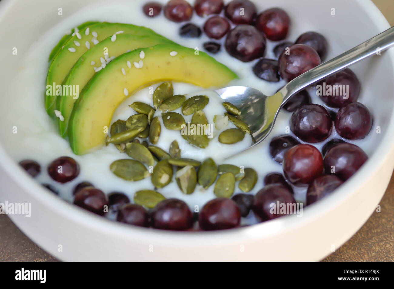 yogurt with grape and avocado topping Stock Photo - Alamy
