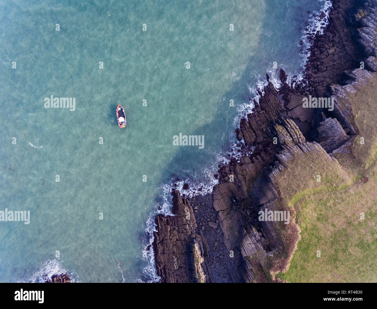 Aerial view of a boat in the Bay at Stackpole Quay, Pembrokeshire ...