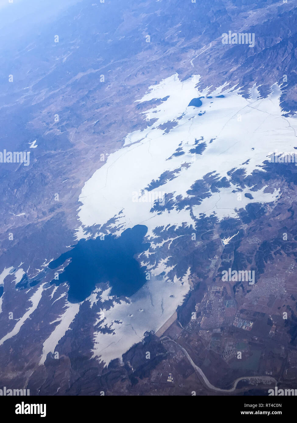 An aerial view of Chinese mountains from the airplane flying high above ...
