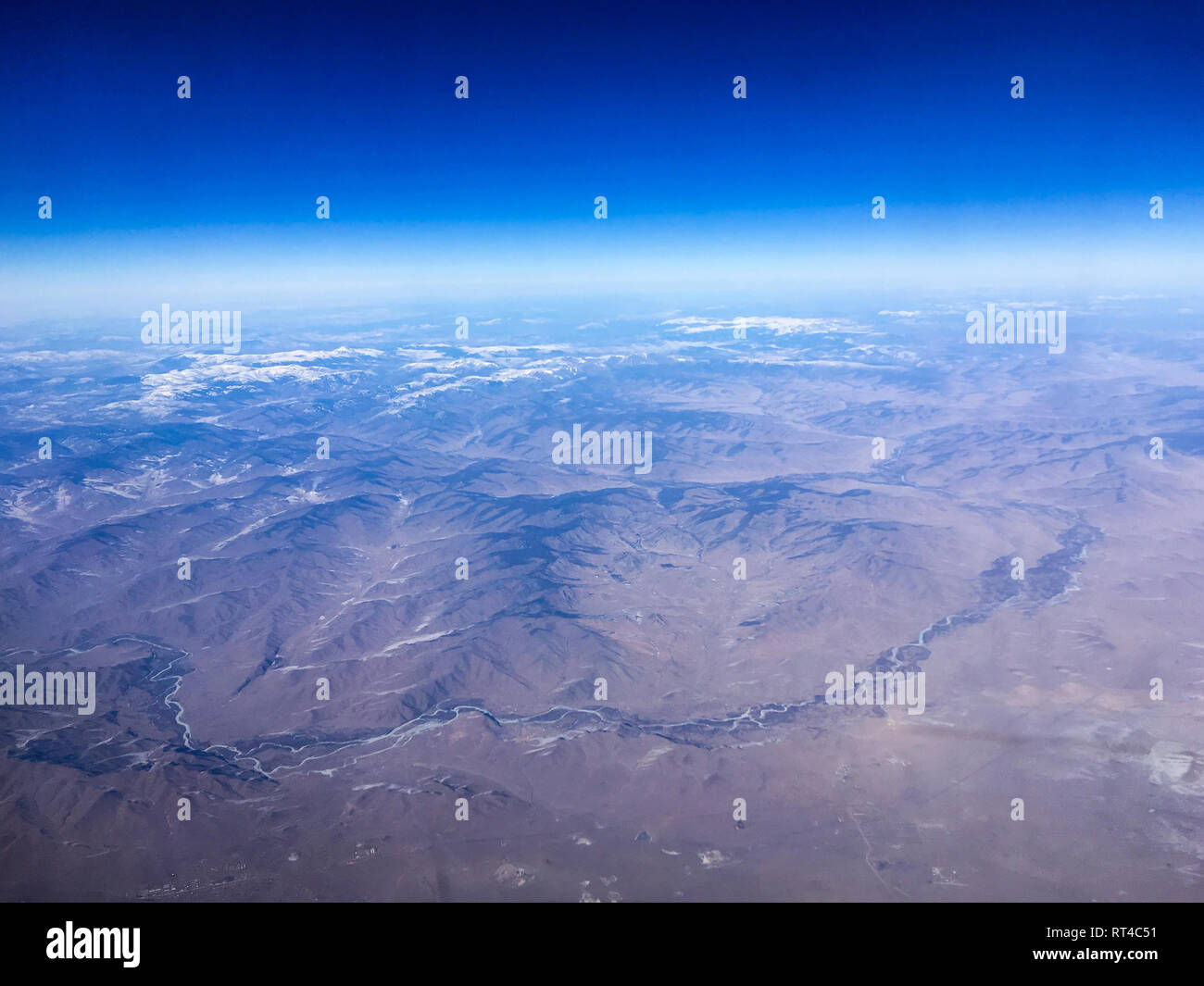An aerial view of Chinese mountains from the airplane flying high above ...