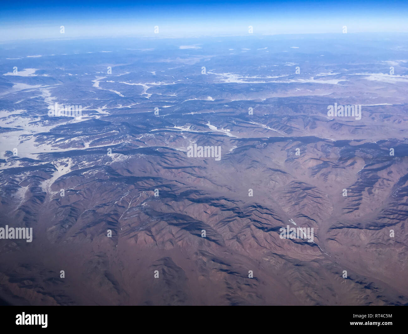 An aerial view of Chinese mountains from the airplane flying high above ...
