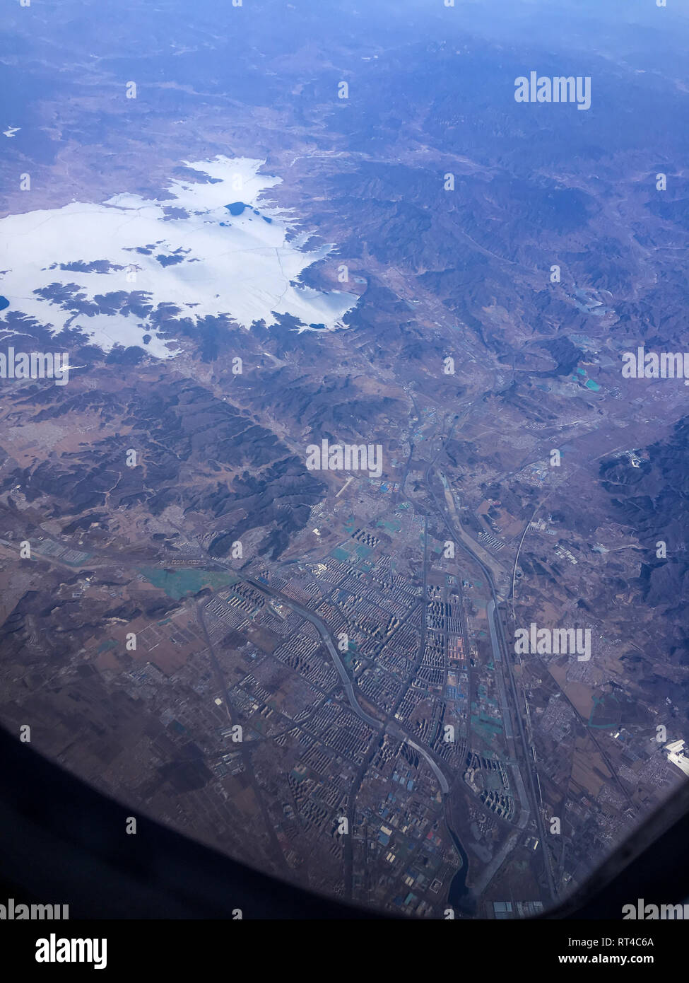 An aerial view of Chinese mountains from the airplane flying high above ...