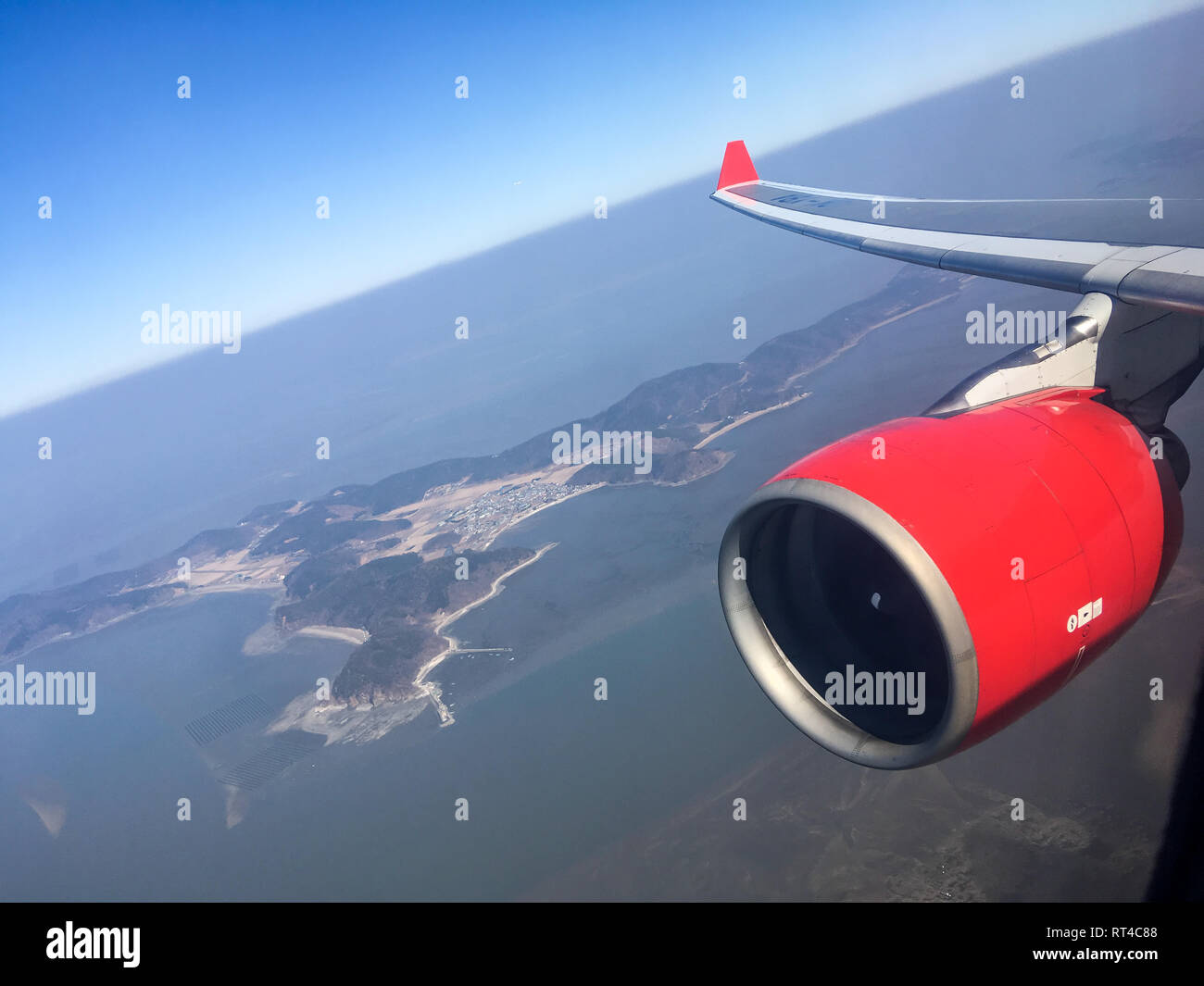 An aerial view from the airplane flying high above the ground. There is ...