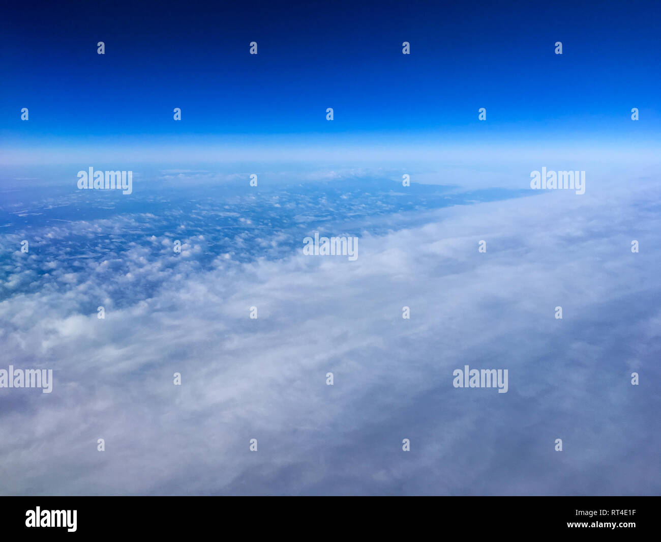 An aerial view from the airplane flying high above the ground. A look ...