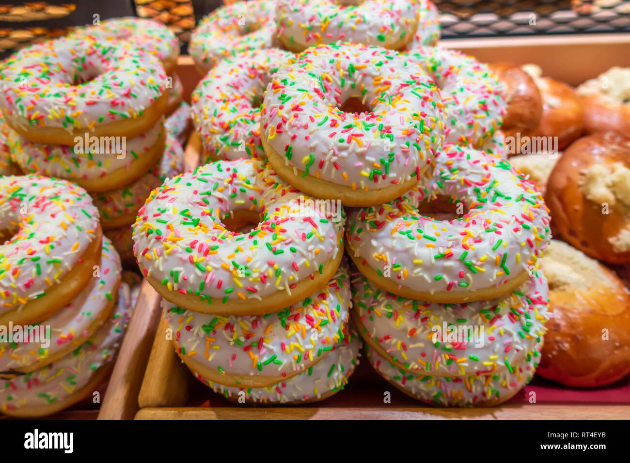 freshly baked glazed donuts with sprinkle in supermarket, food concept ...
