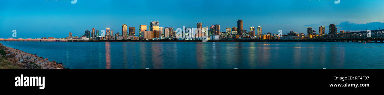 beautiful landscape of Osaka city with modern buildings and river ...