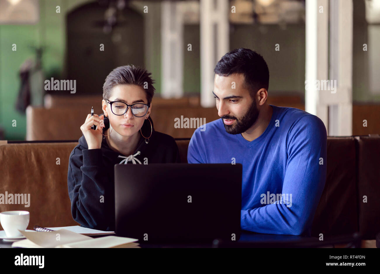 Students talking with each other planning startup strategy during ...