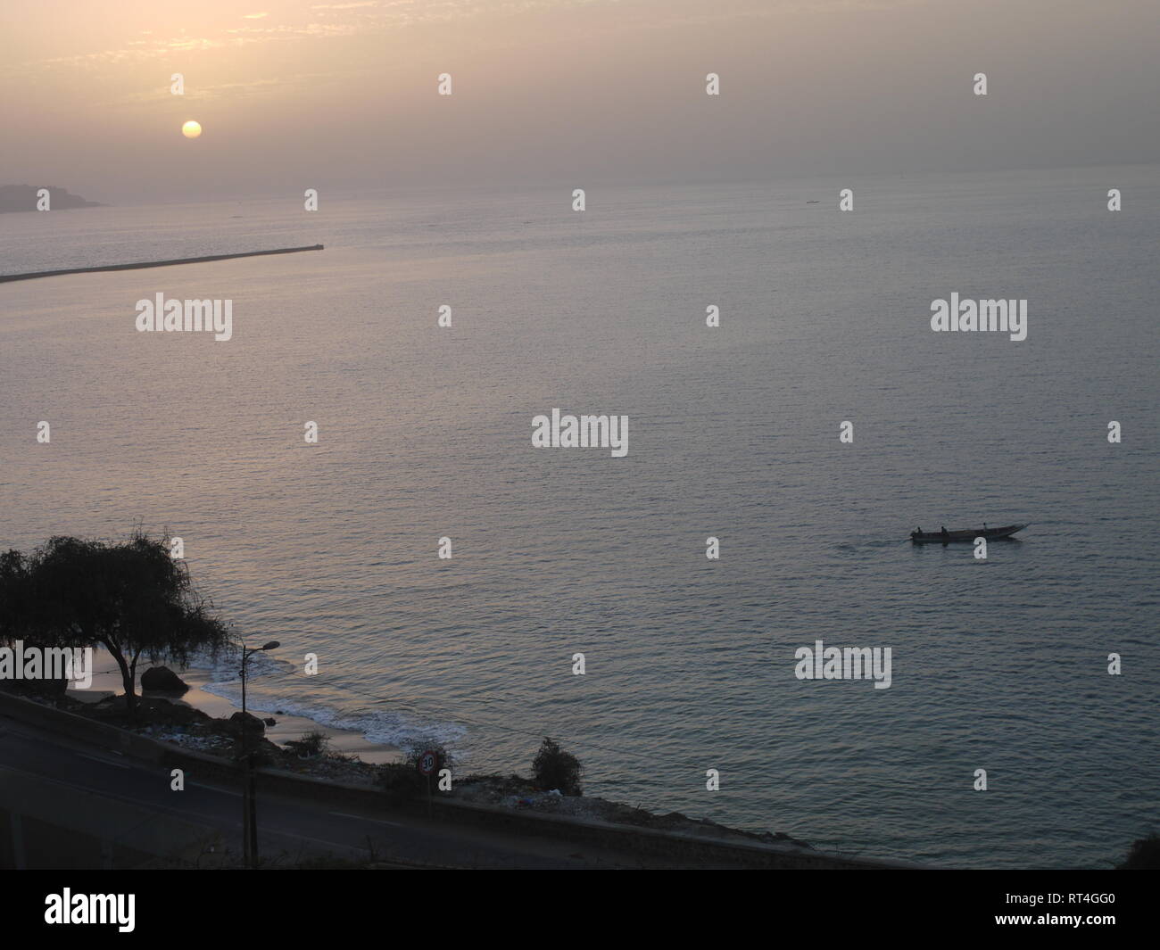 Fisherman's canoe on the ocean facing the Senegalese coast a sunrise ...