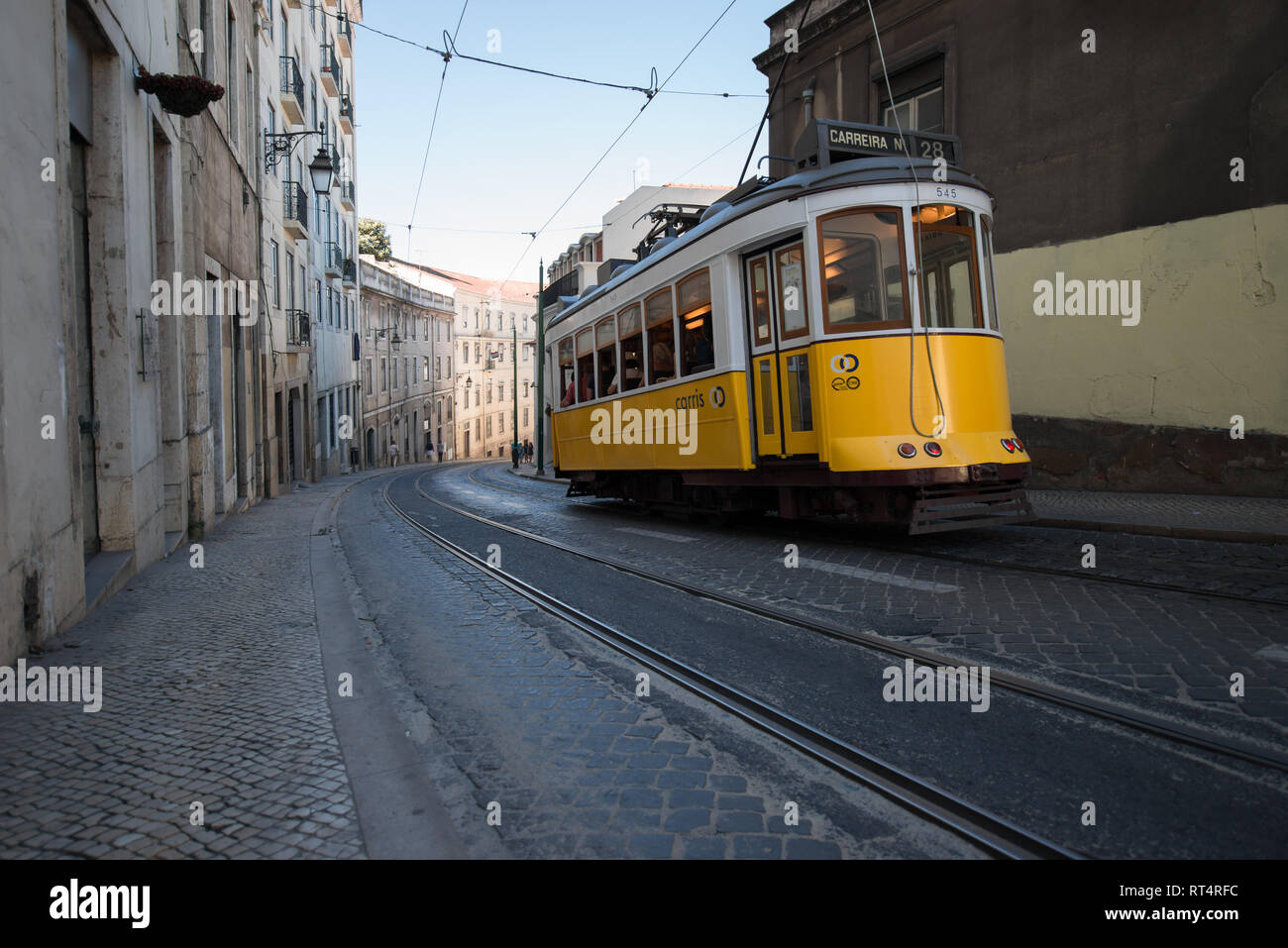 Tram 28 : the famous and vintage old yellow tram 28 passing on street ...