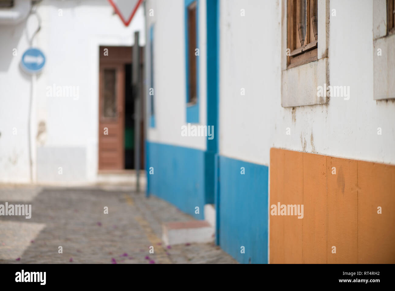 Blue and orange exterior walls in Tavira. Colorful houses in Algarve ...