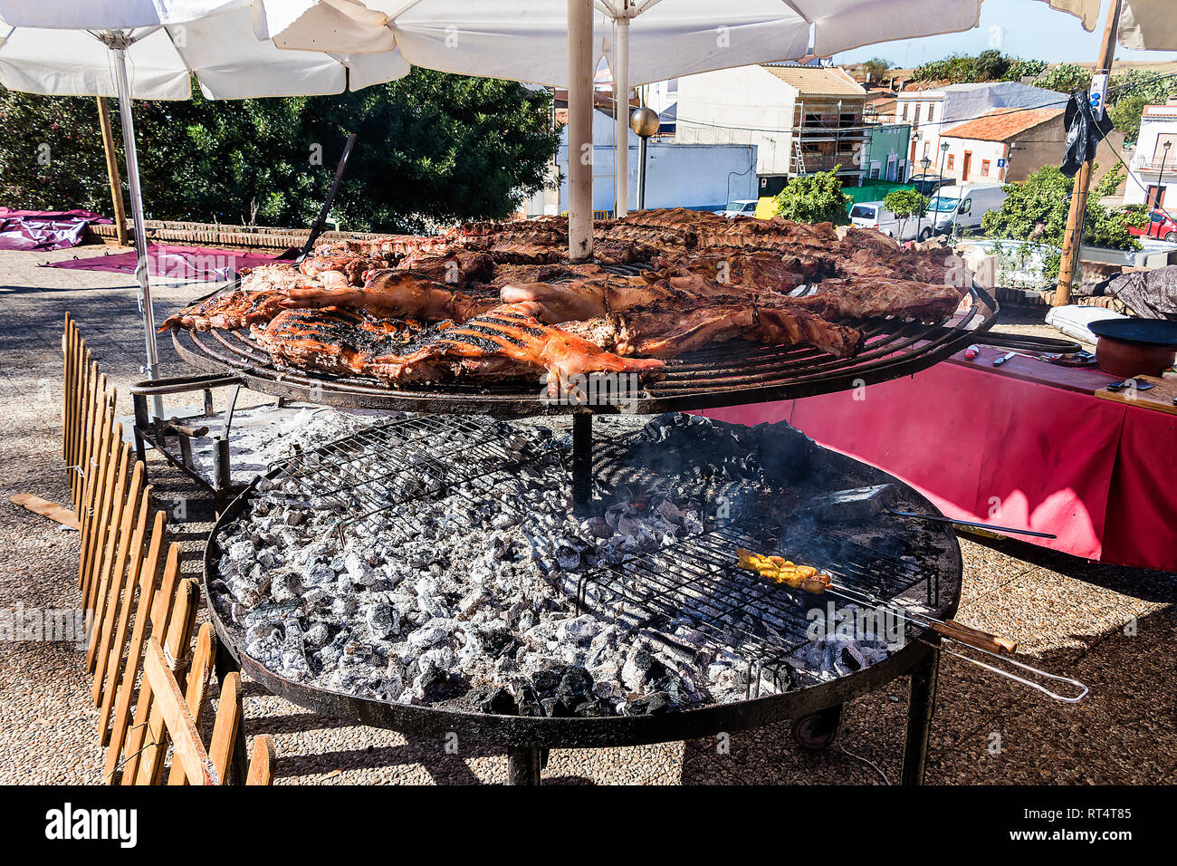 Assortment of grilled sausages and kebabs on big round grill in ...
