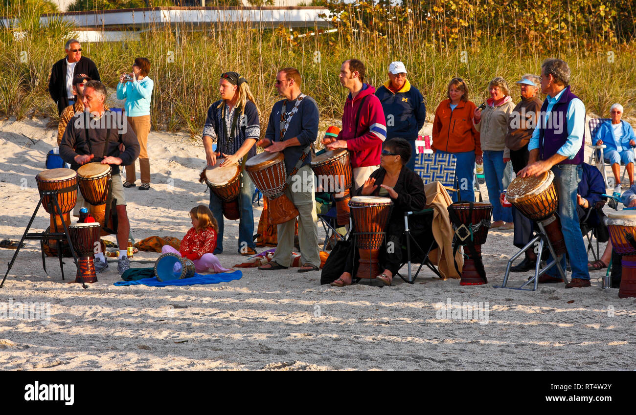 people drumming; sand beach; group; musicians; entertainment; sunset ...